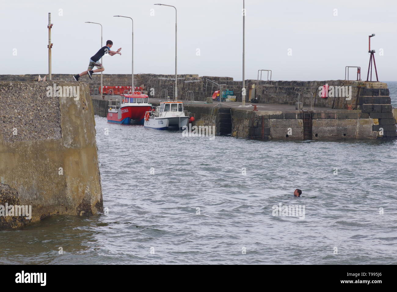 Two Teenage Lads Jumping from the Harbour Wall into the Sea at St ...