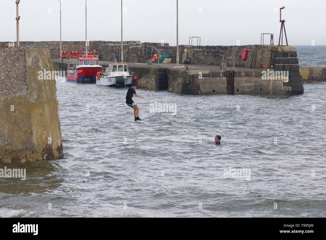 Two Teenage Lads Jumping from the Harbour Wall into the Sea at St ...