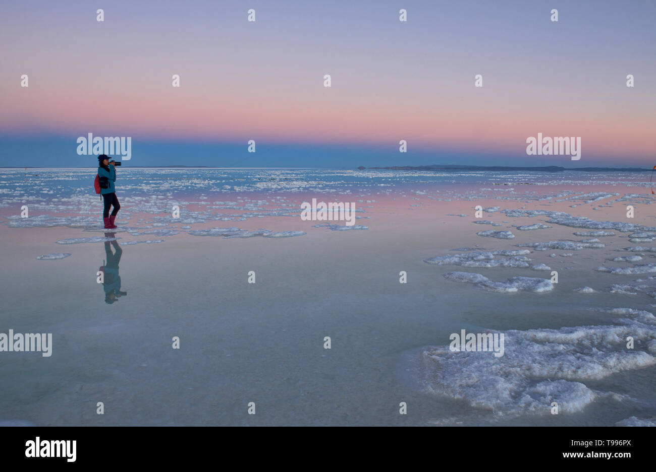 Sunset reflections on the vast salt flat of Salar de Uyuni, Bolivia ...
