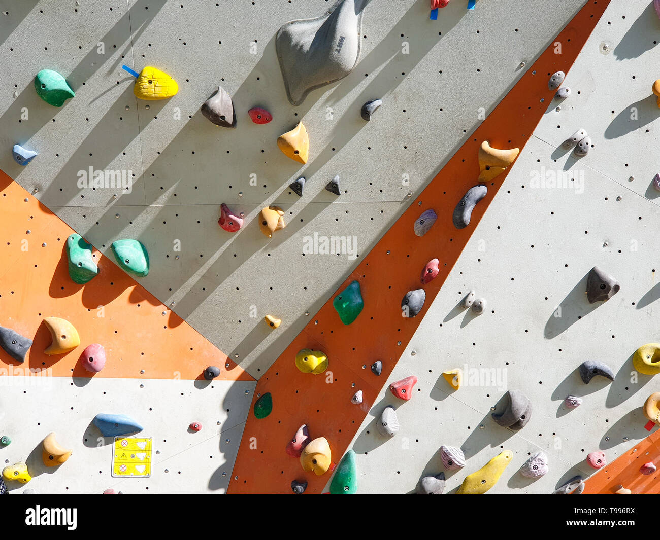 Indoor and outdoor sports climbing stone wall Stock Photo - Alamy