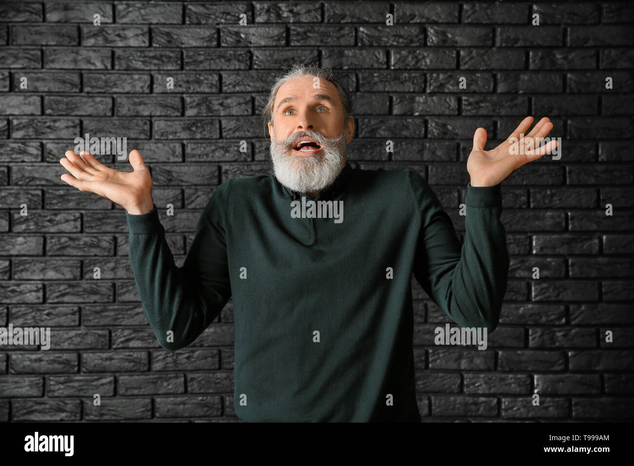 Emotional senior man after making mistake on dark background Stock ...