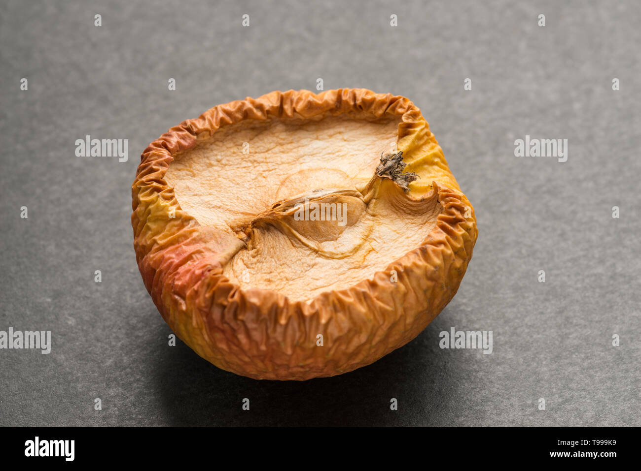 Slice of withered apple on a dark background. Selective focus Stock ...