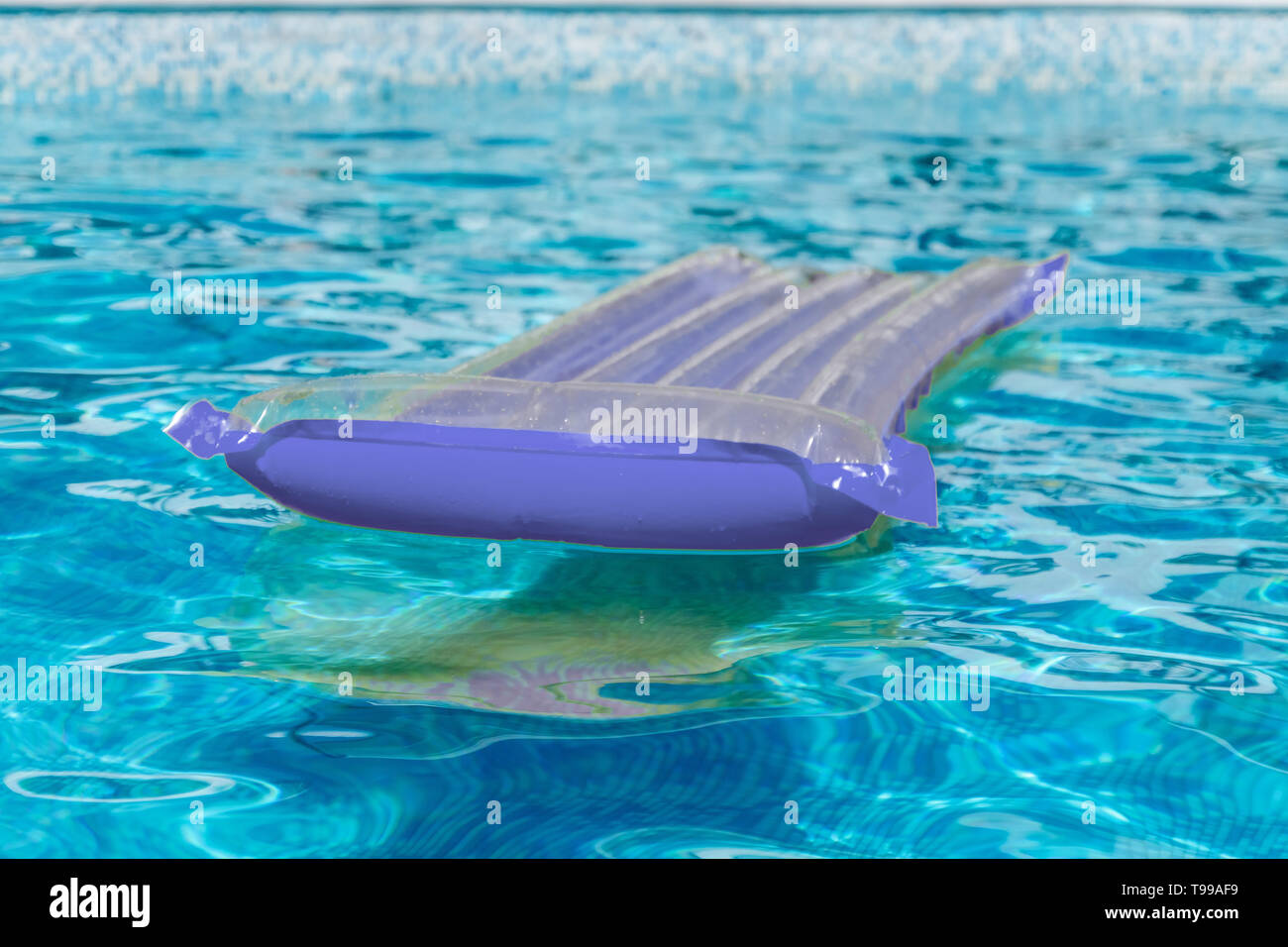 Inflatable water activities mattresses float on the water in the pool ...