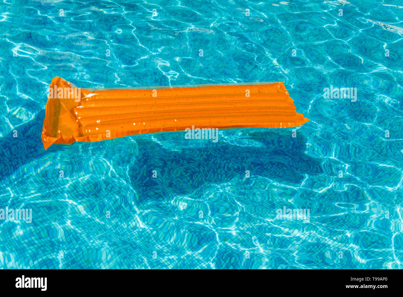 Inflatable water activities mattresses float on the water in the pool ...