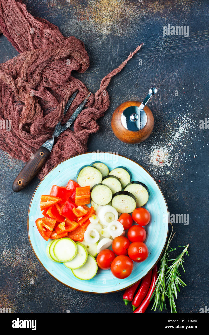 raw vegetables on plate on a table Stock Photo - Alamy