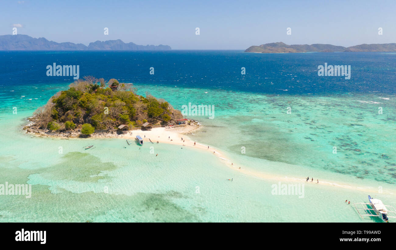 A small island for tourists with a sand bar.Tourists rest on a small ...