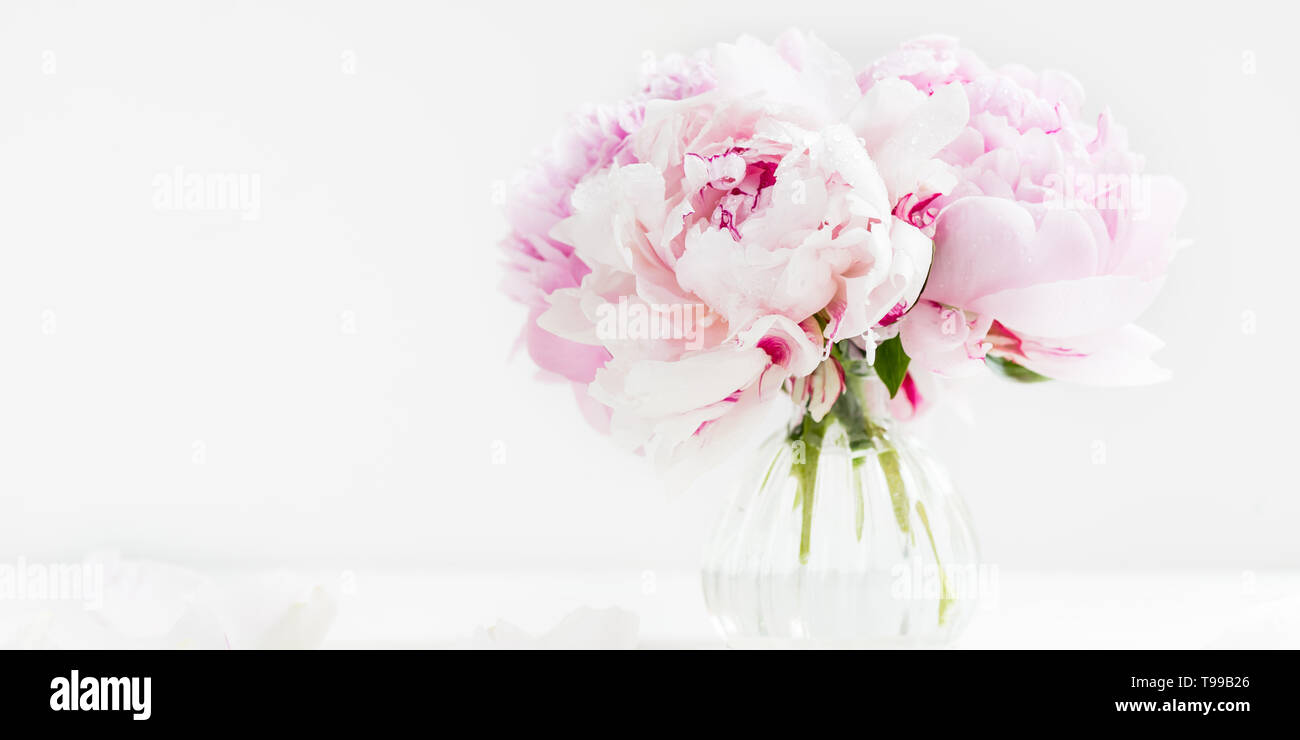 Fresh bunch of pink peonies on light background Stock Photo - Alamy