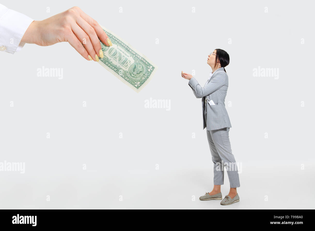 The smallest earnings in history. Young woman in grey suit getting a ...