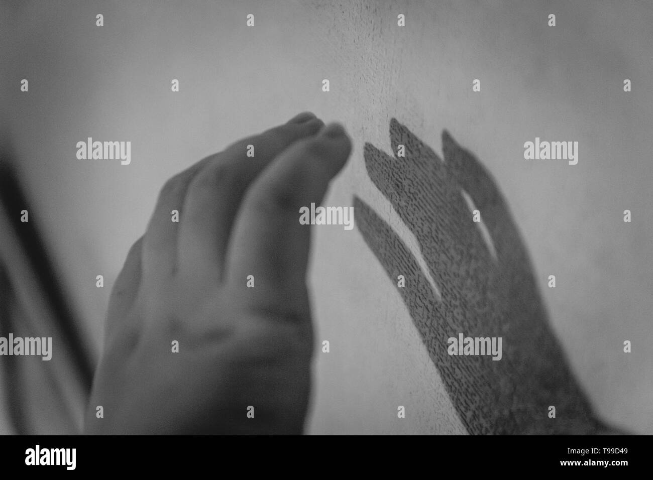 Scary hand shadow on wall hi-res stock photography and images - Alamy