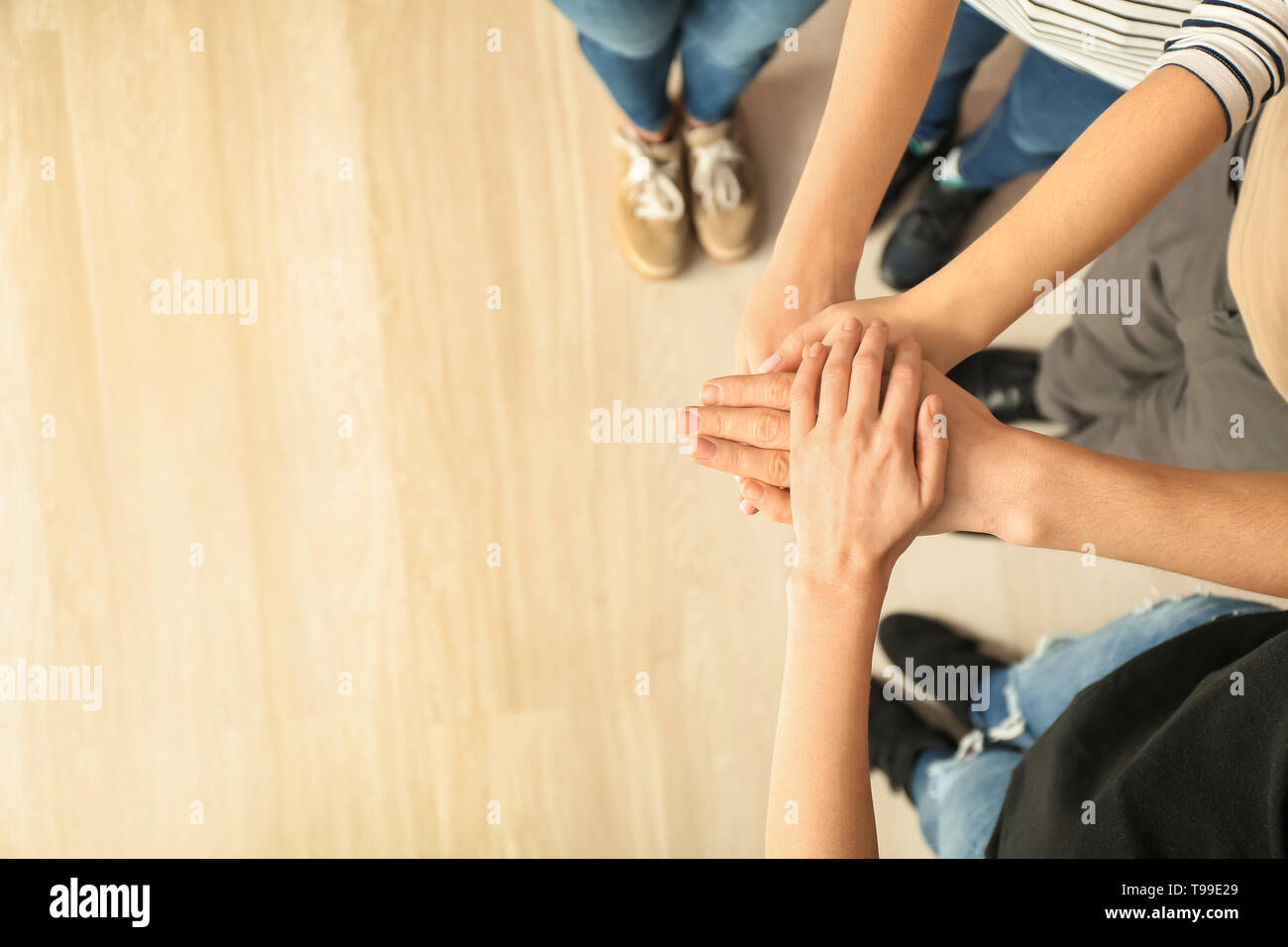 Young people putting hands together, top view. Concept of unity Stock ...