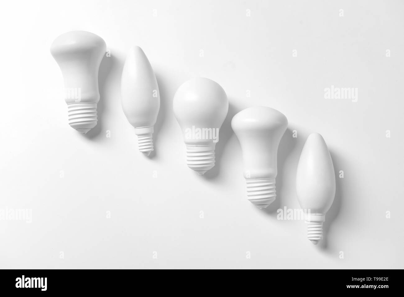 Different light bulbs on white background Stock Photo - Alamy