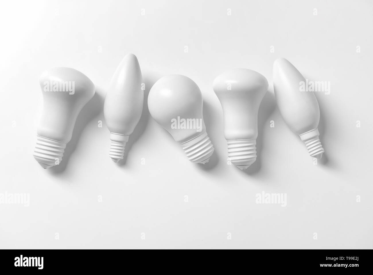 Different light bulbs on white background Stock Photo - Alamy