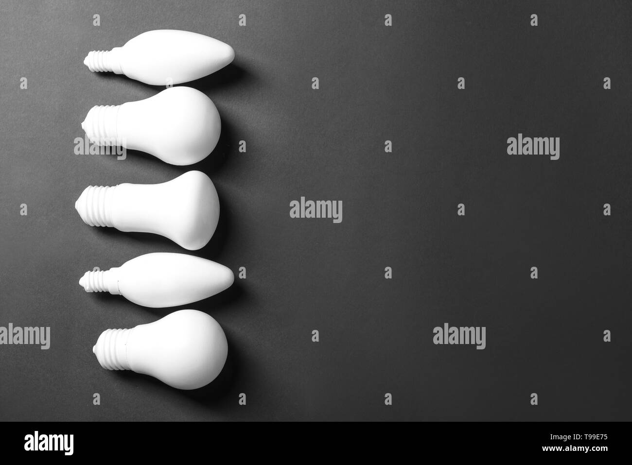 Different light bulbs on dark background Stock Photo - Alamy