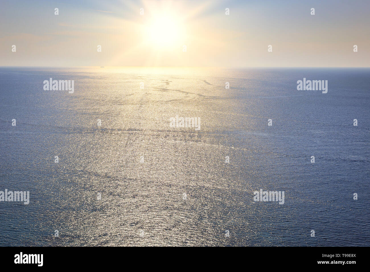The brilliant sun shines and reflect on the water surface above the sea ...