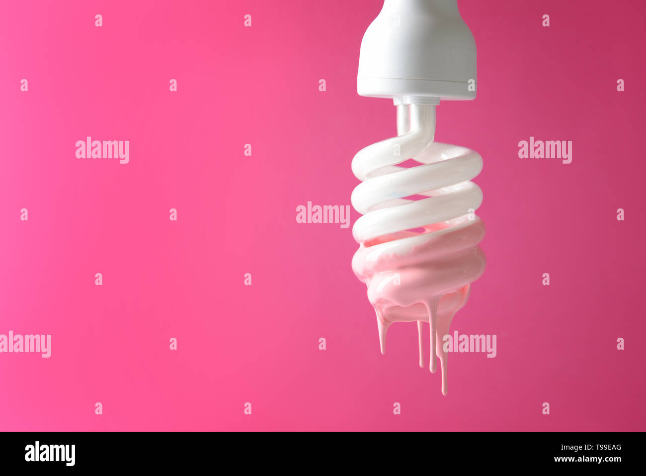 Paint dripping from light bulb on color background Stock Photo - Alamy