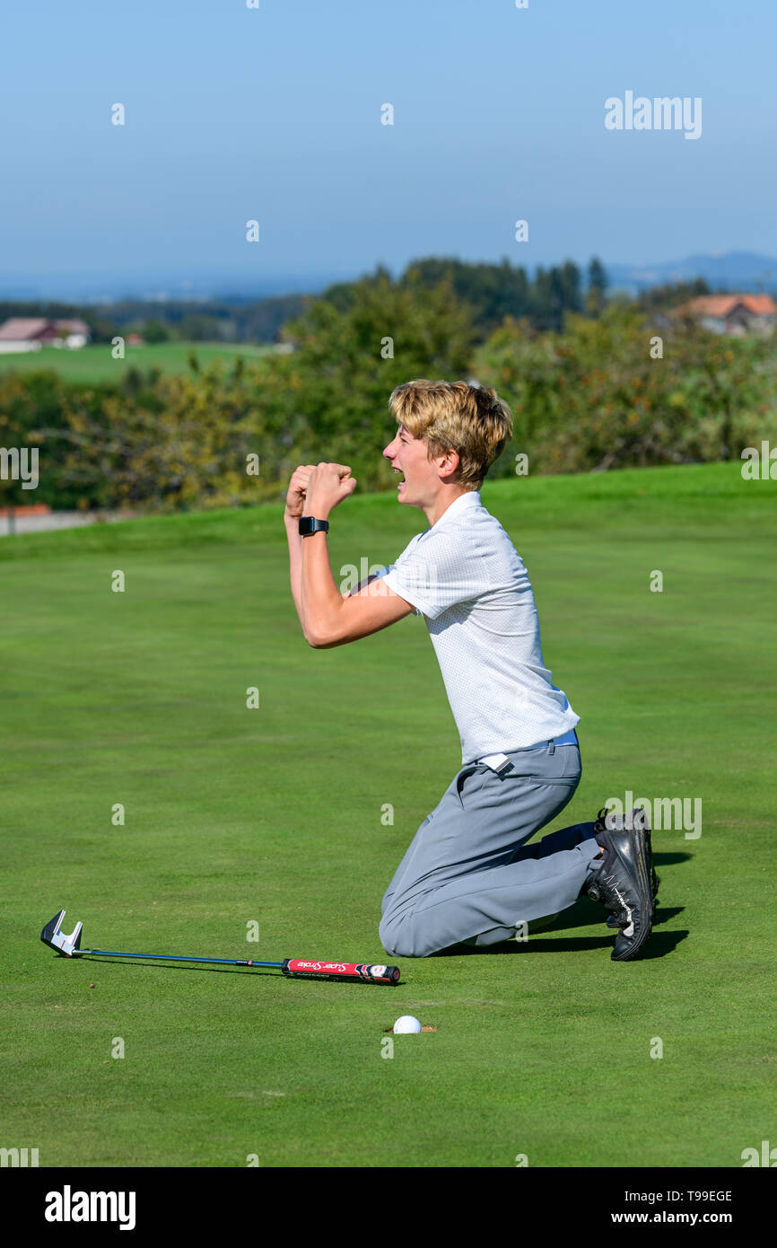 Junior golfer disappointed about a mishit on green Stock Photo - Alamy
