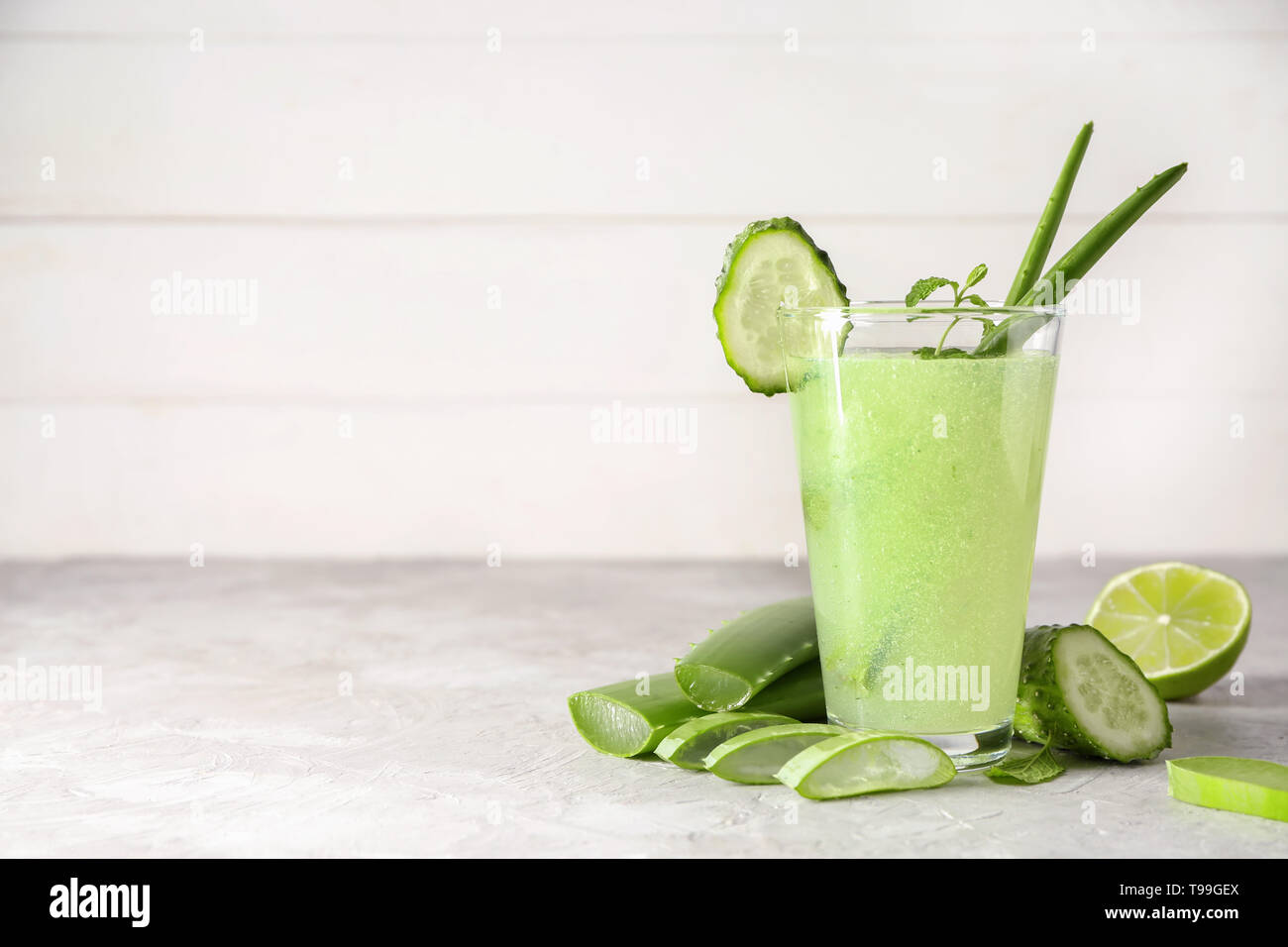 Glass of healthy aloe cocktail on table Stock Photo - Alamy