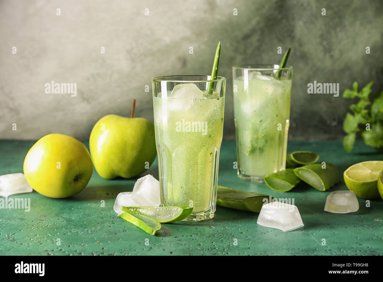 Glasses of healthy aloe cocktail on color table Stock Photo - Alamy