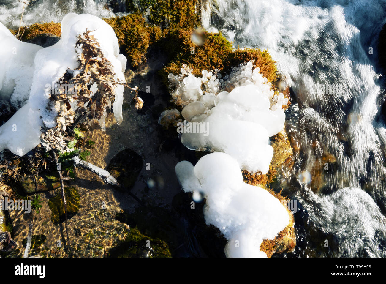 Mountain river on frosty day and icing stones. Becomes clear mechanism ...