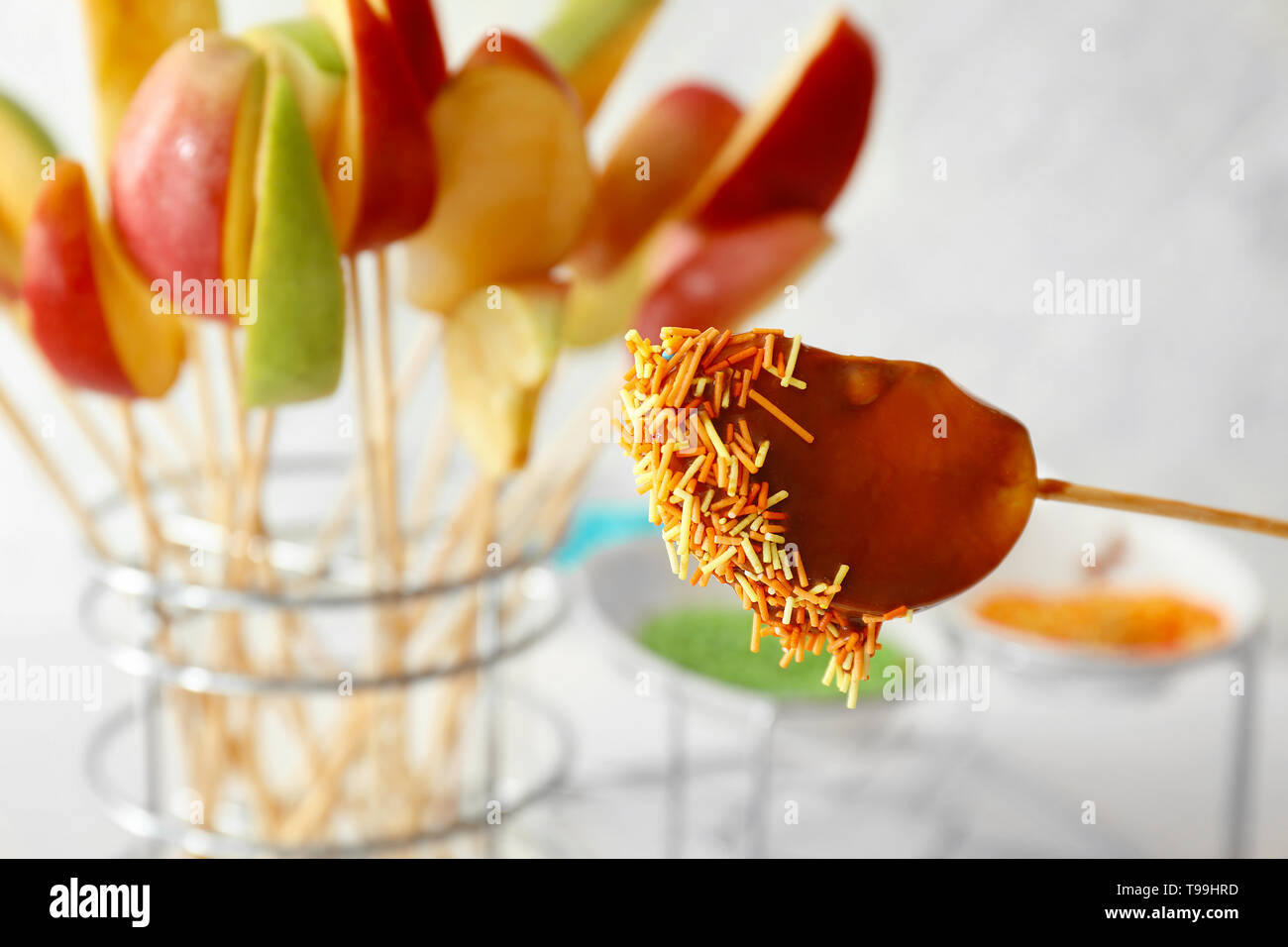 Stick with candy apple wedge Stock Photo - Alamy