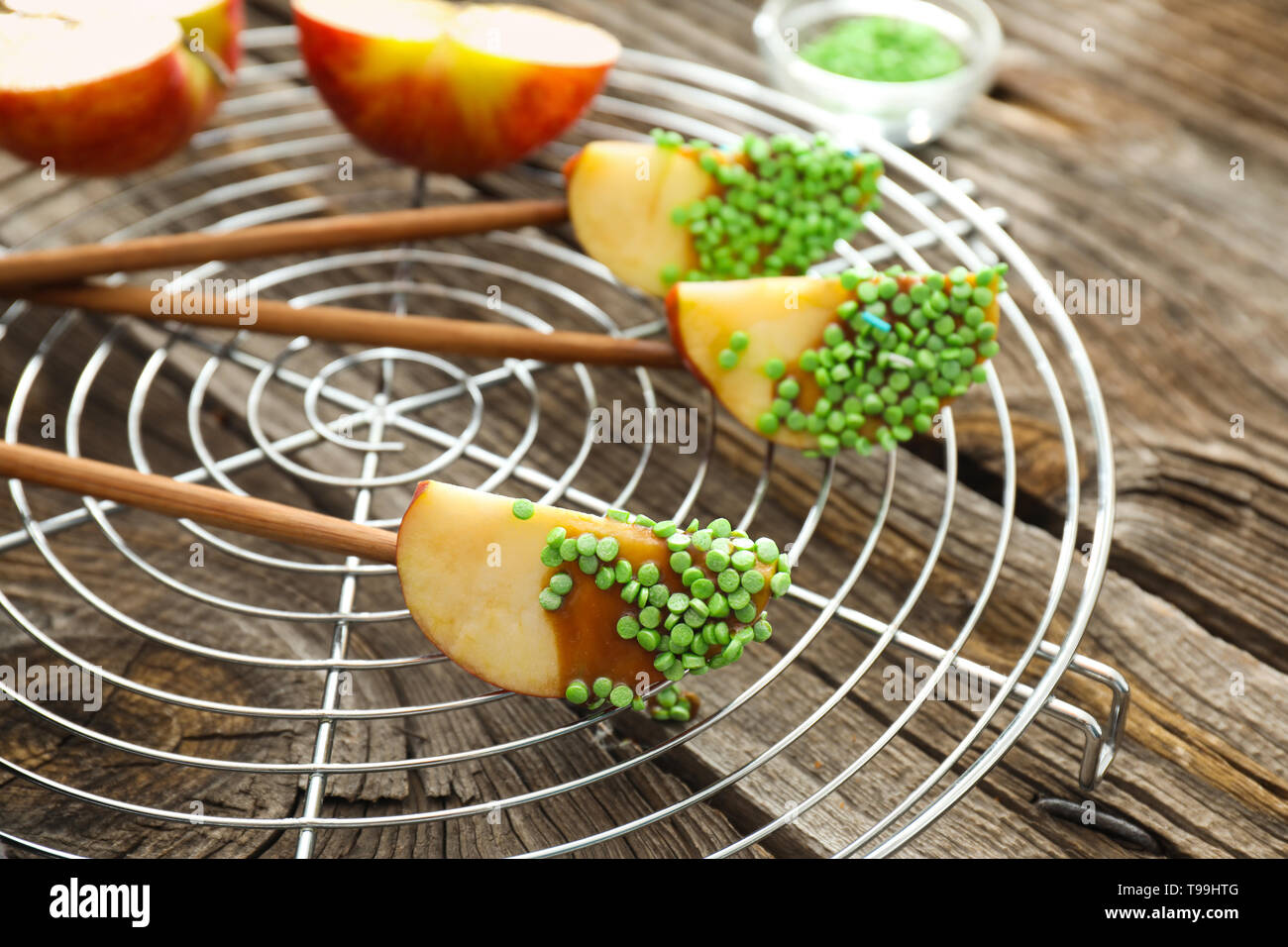 Sticks with candy apple wedges on cooling rack Stock Photo - Alamy