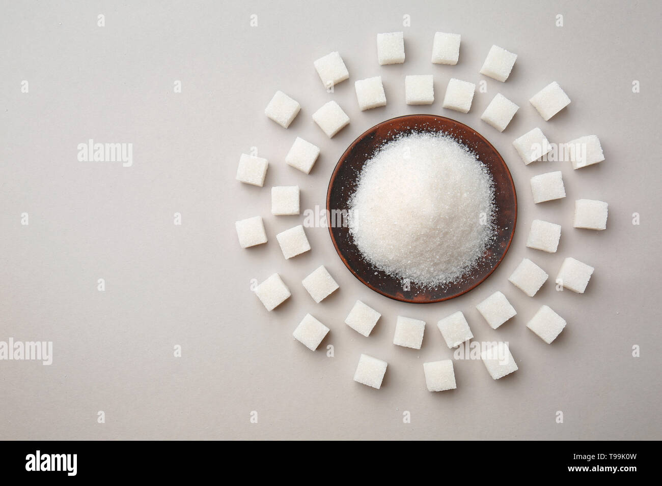 Composition made of refined sugar on light background Stock Photo - Alamy