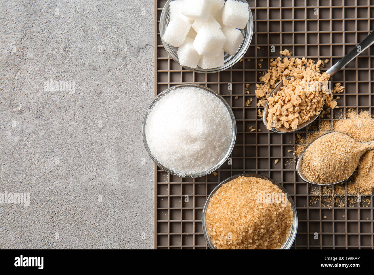 Different kinds of sugar on grey table Stock Photo - Alamy