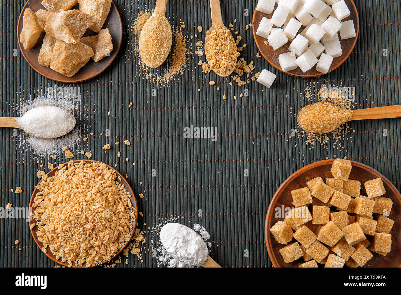 Different kinds of sugar on dark table Stock Photo - Alamy