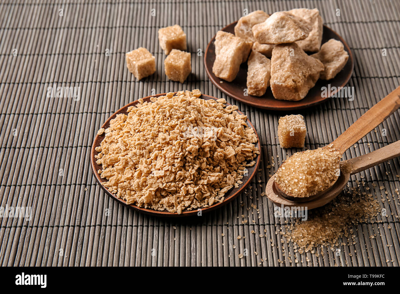 Plates and spoons with varieties of sugar on table Stock Photo - Alamy