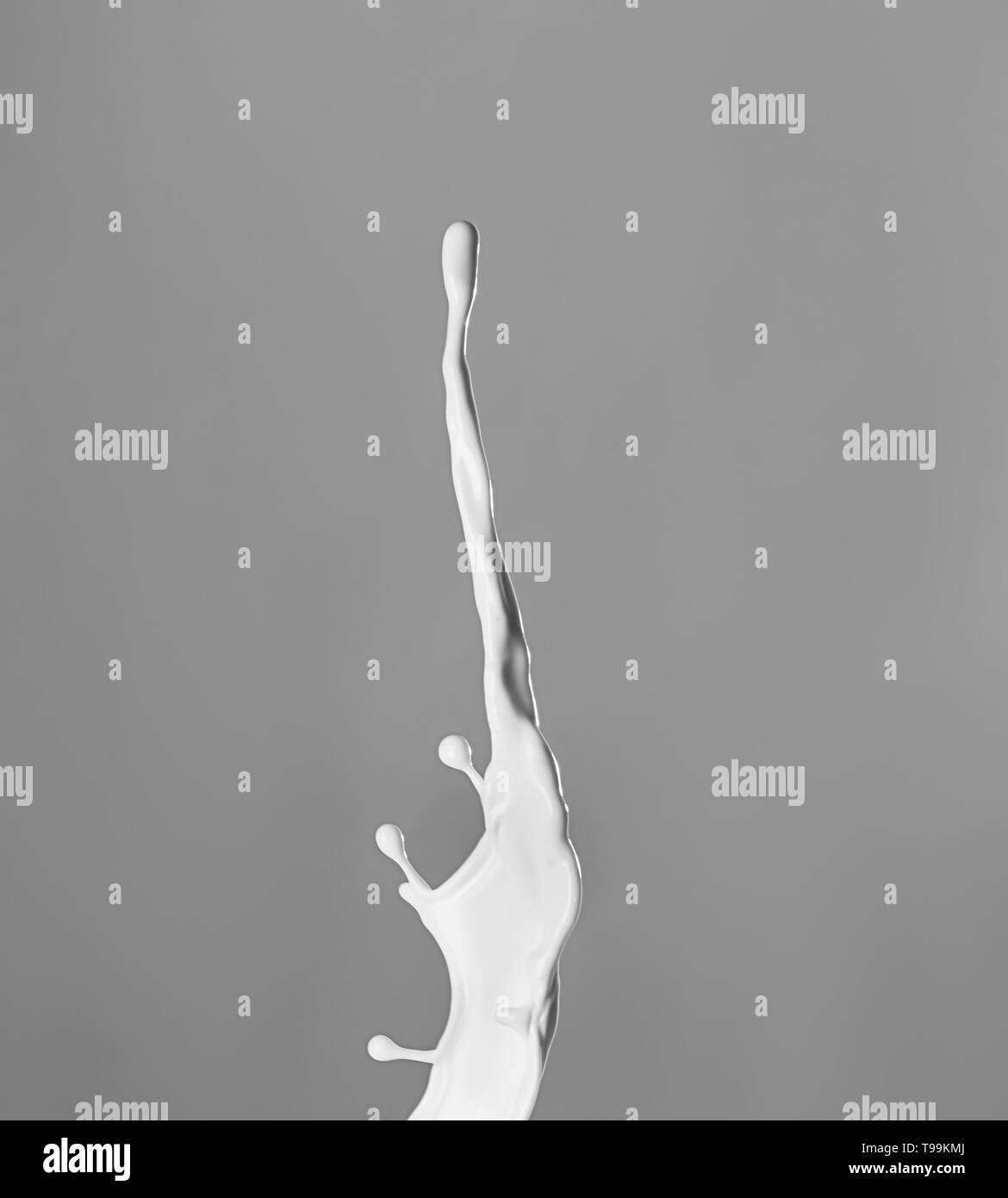 Splash of milk on grey background Stock Photo - Alamy