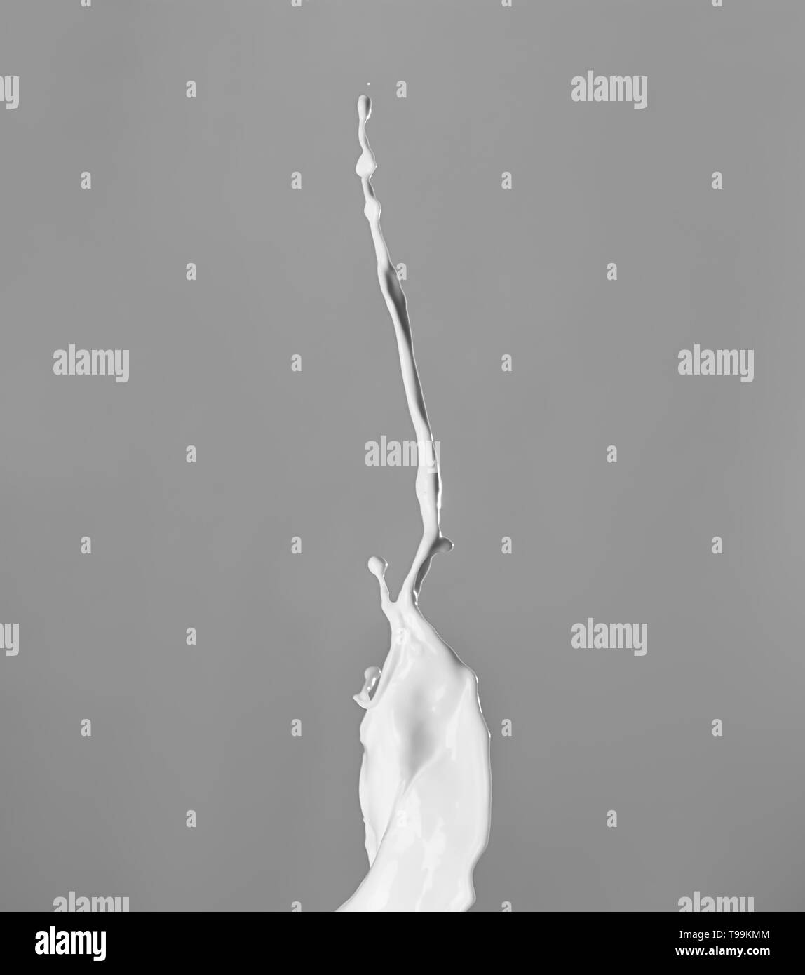Splash of milk on grey background Stock Photo - Alamy