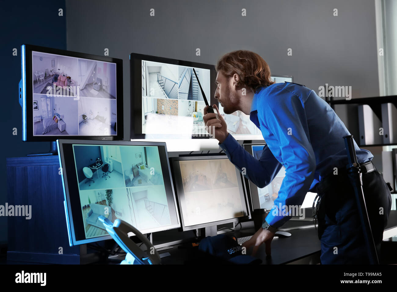 Security guard monitoring modern CCTV cameras in surveillance room ...