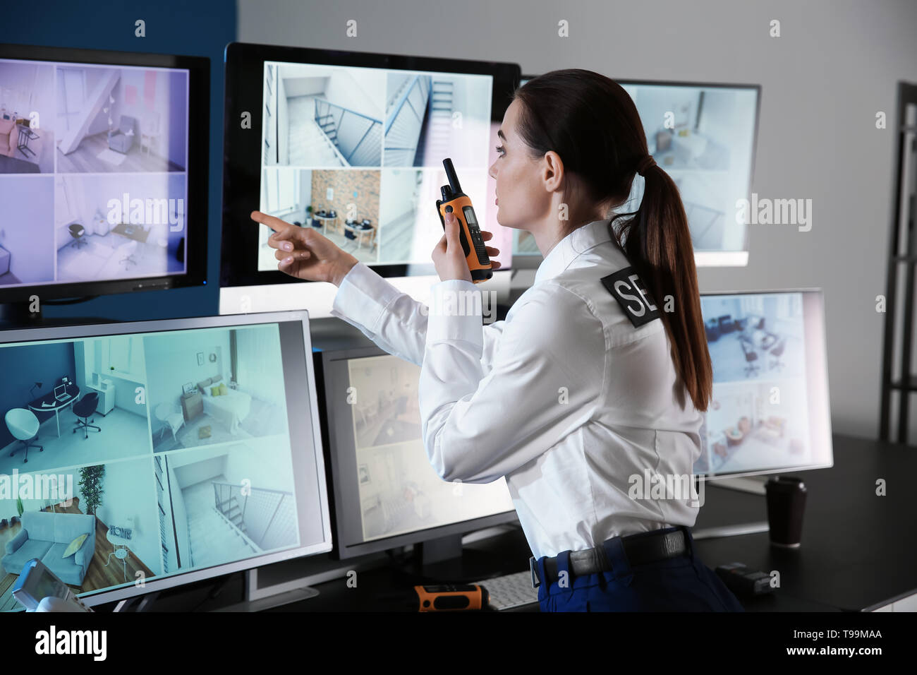 Security guard monitoring modern CCTV cameras in surveillance room ...