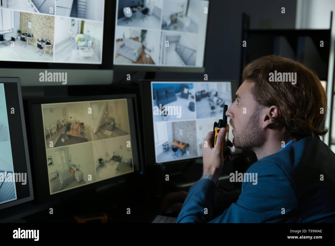 Security guard monitoring modern CCTV cameras in surveillance room ...