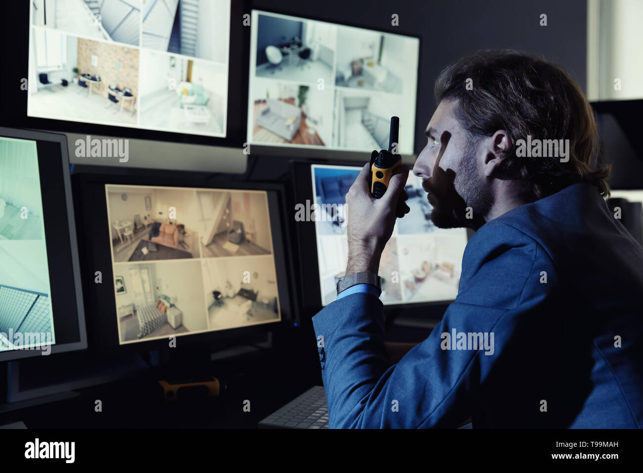 Security guard monitoring modern CCTV cameras in surveillance room ...