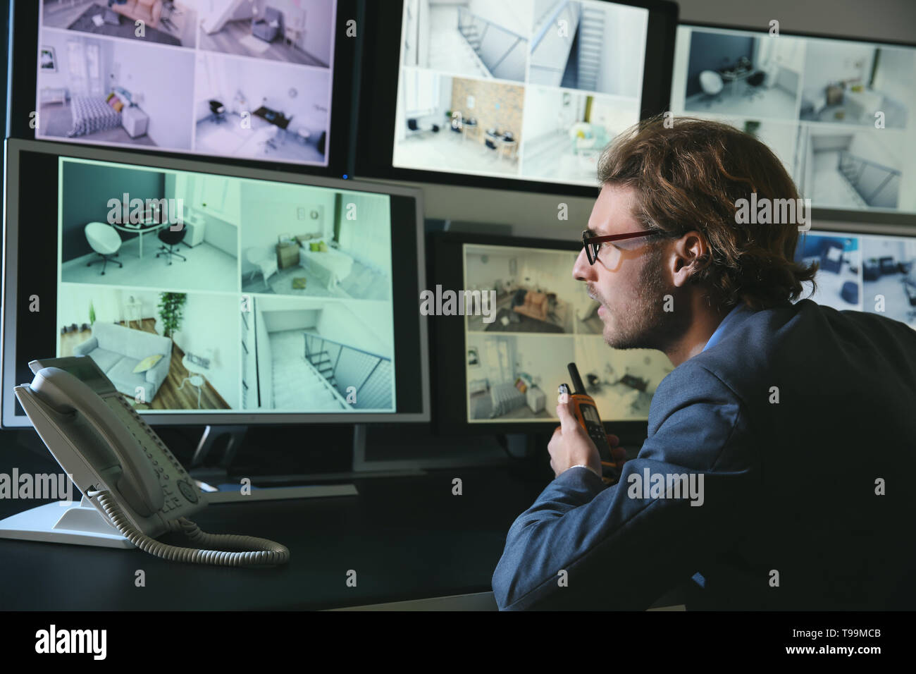 Security guard monitoring modern CCTV cameras in surveillance room ...