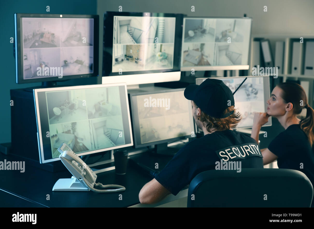 Security guards monitoring modern CCTV cameras in surveillance room ...
