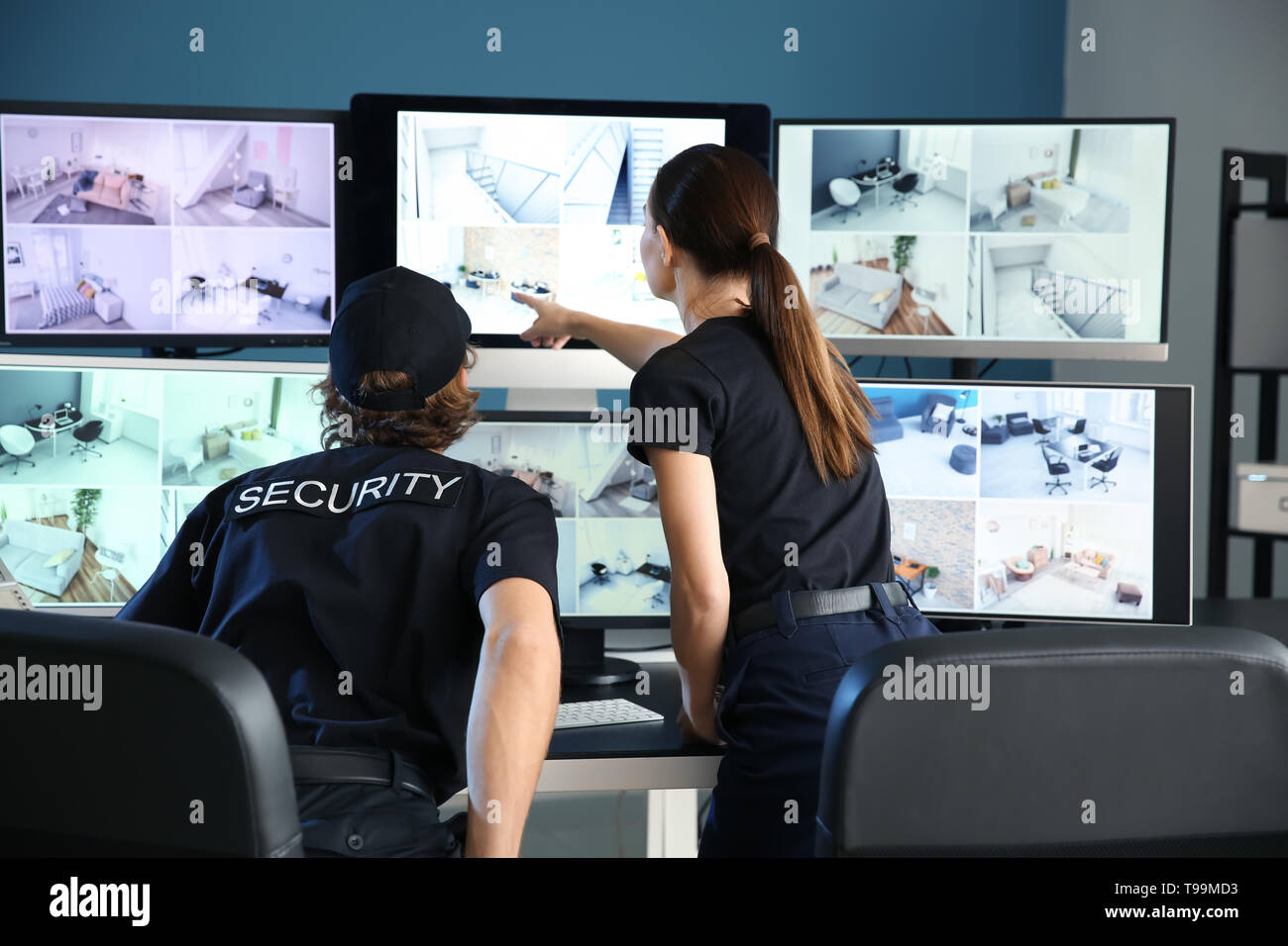 Security guards monitoring modern CCTV cameras in surveillance room ...