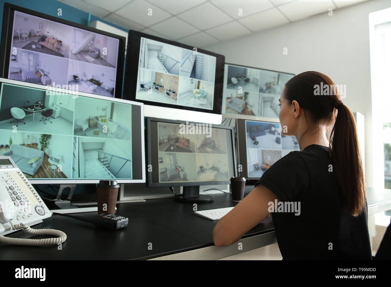 Security guard monitoring modern CCTV cameras in surveillance room ...