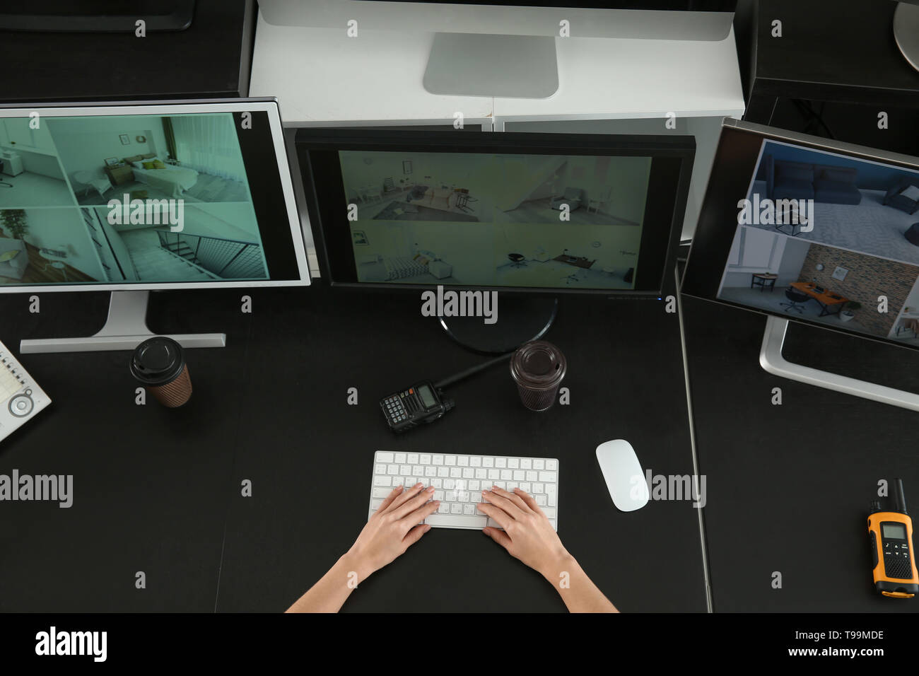 Security guard monitoring modern CCTV cameras in surveillance room ...