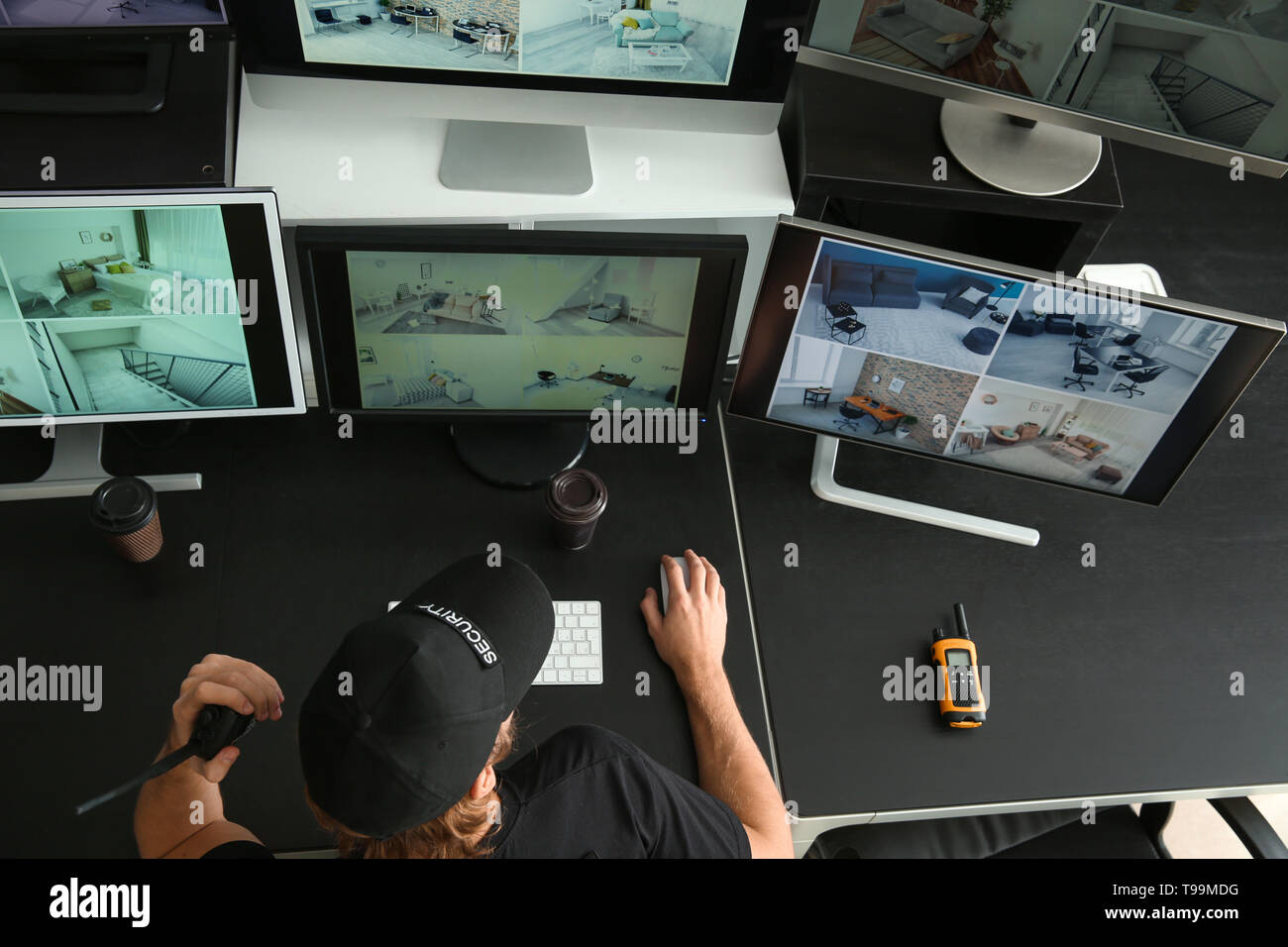 Security guard monitoring modern CCTV cameras in surveillance room ...