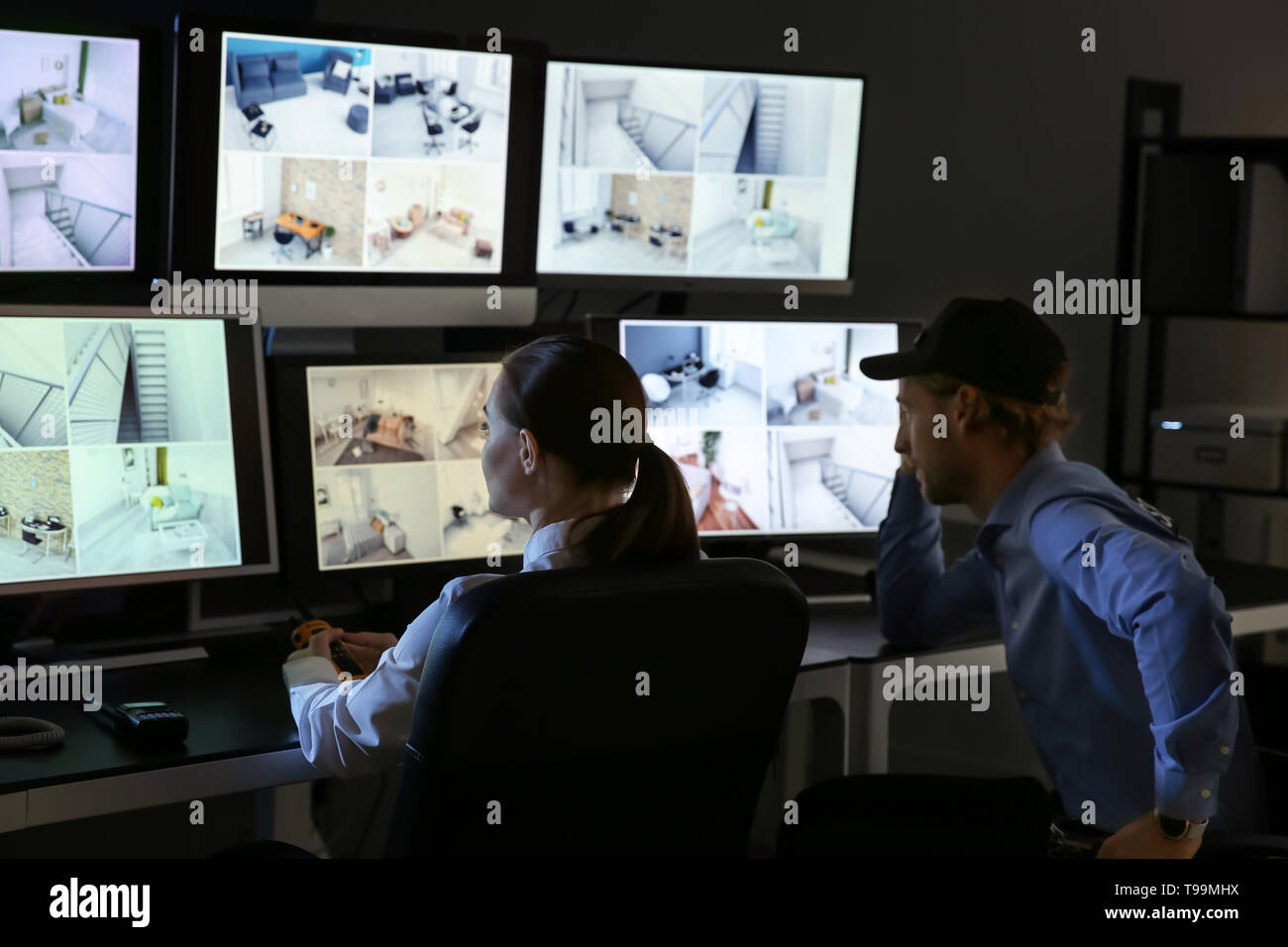 Security guards monitoring modern CCTV cameras in surveillance room ...