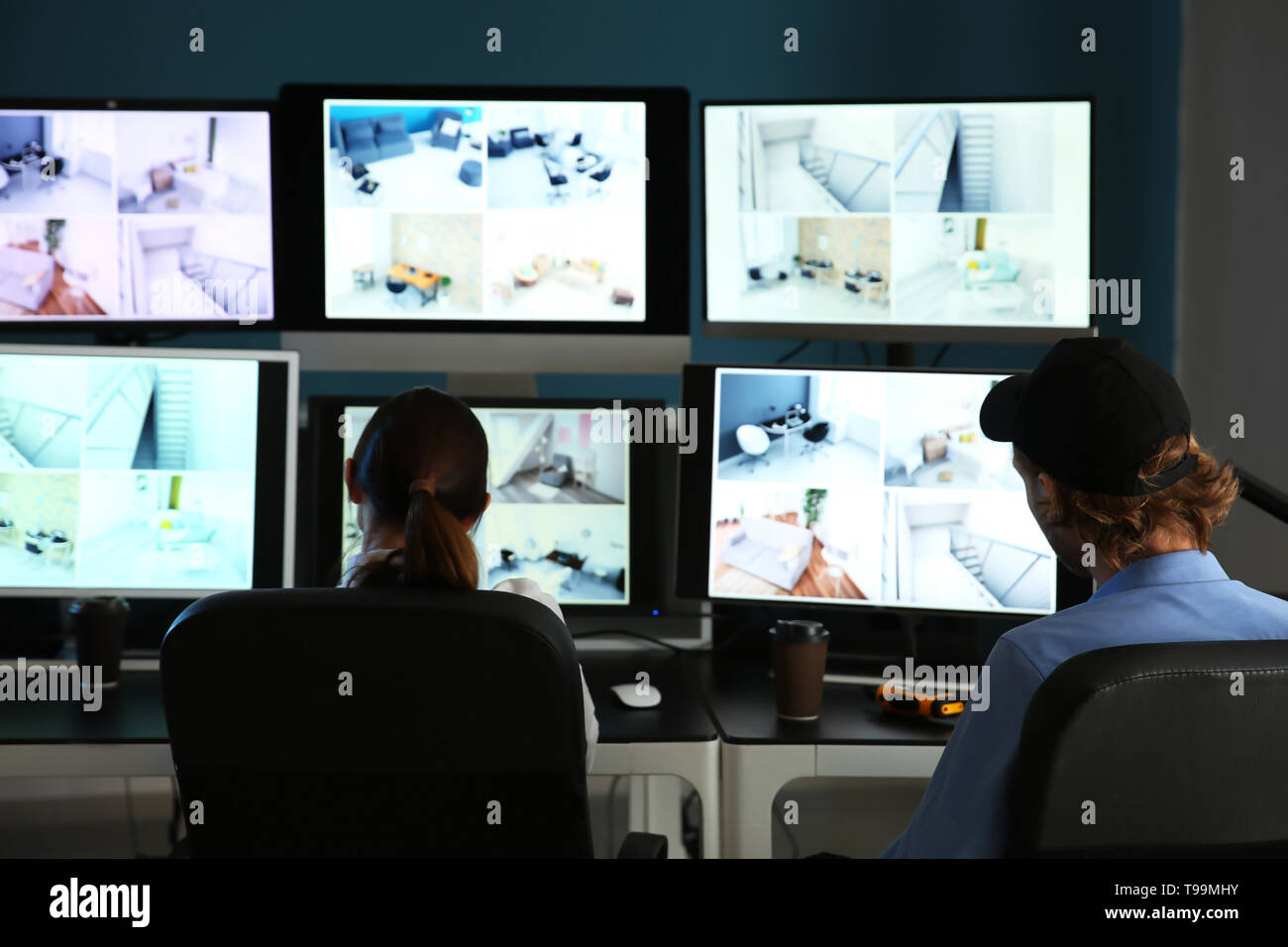 Security guards monitoring modern CCTV cameras in surveillance room ...