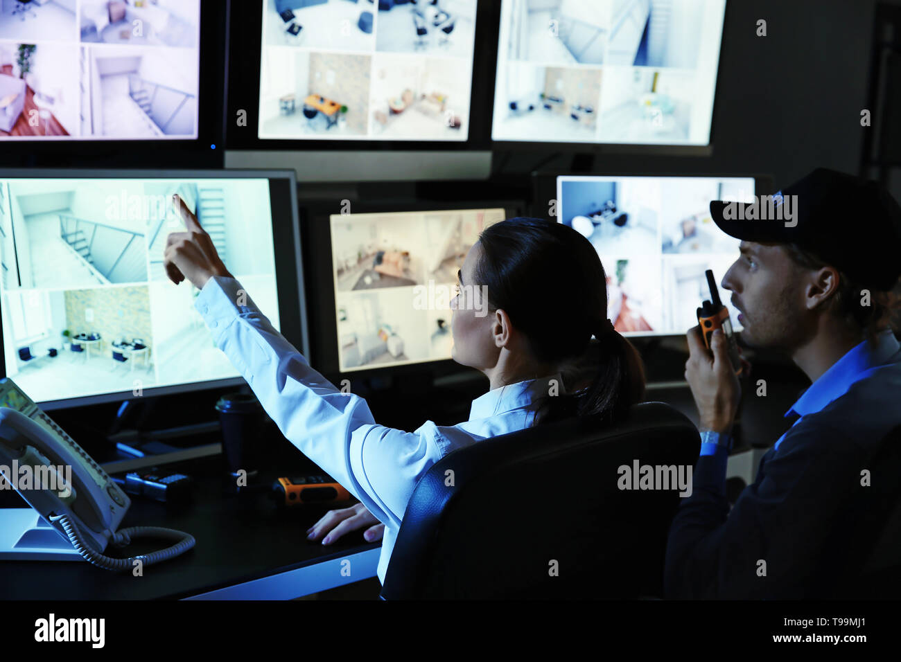 Security guards monitoring modern CCTV cameras in surveillance room ...
