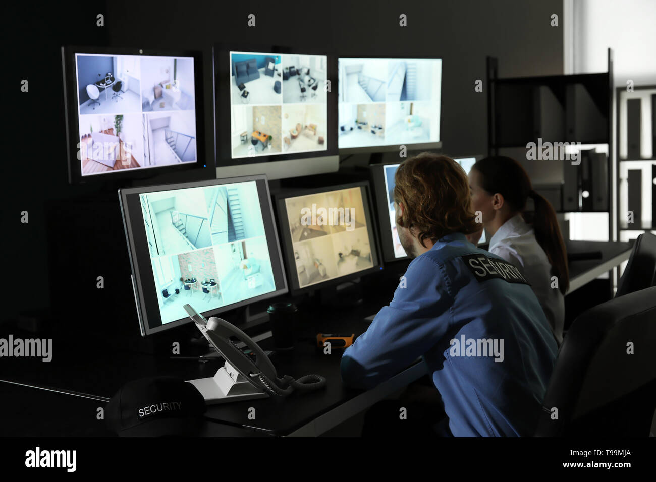 Security guards monitoring modern CCTV cameras in surveillance room ...