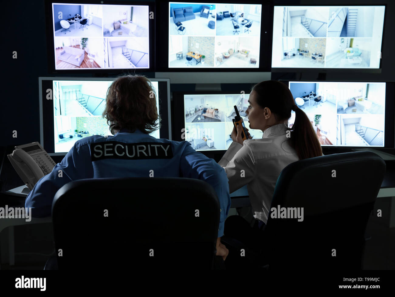 Security guards monitoring modern CCTV cameras in surveillance room ...