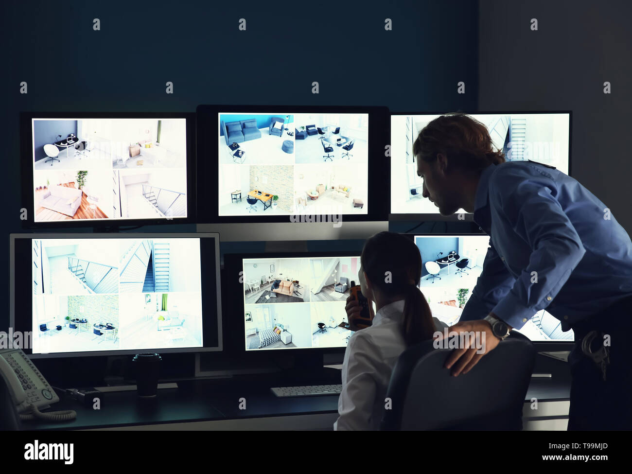 Security guards monitoring modern CCTV cameras in surveillance room ...