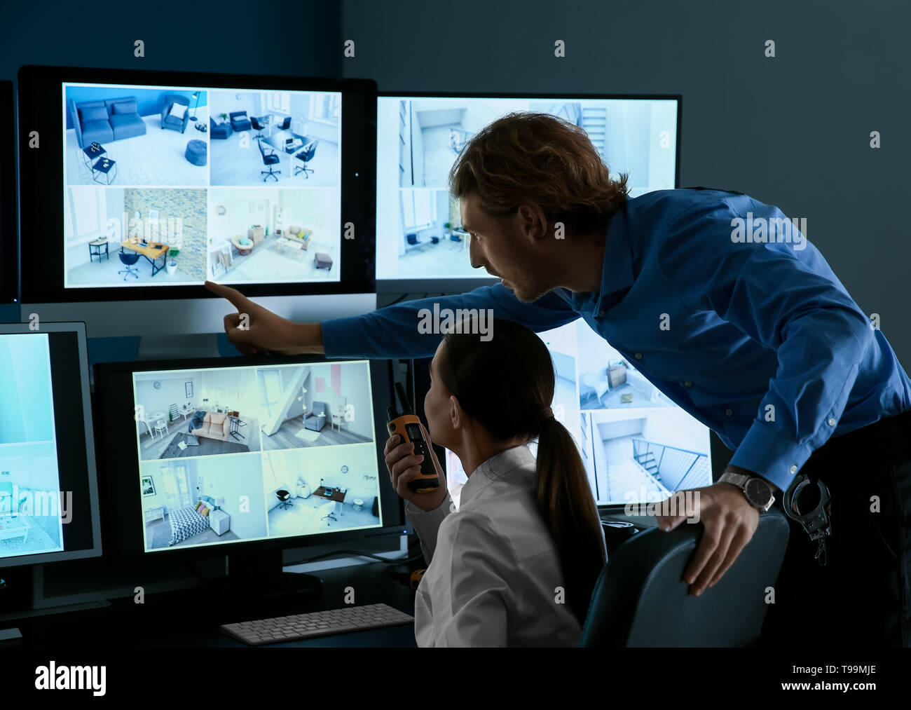 Male female security guards cctv hi-res stock photography and images ...