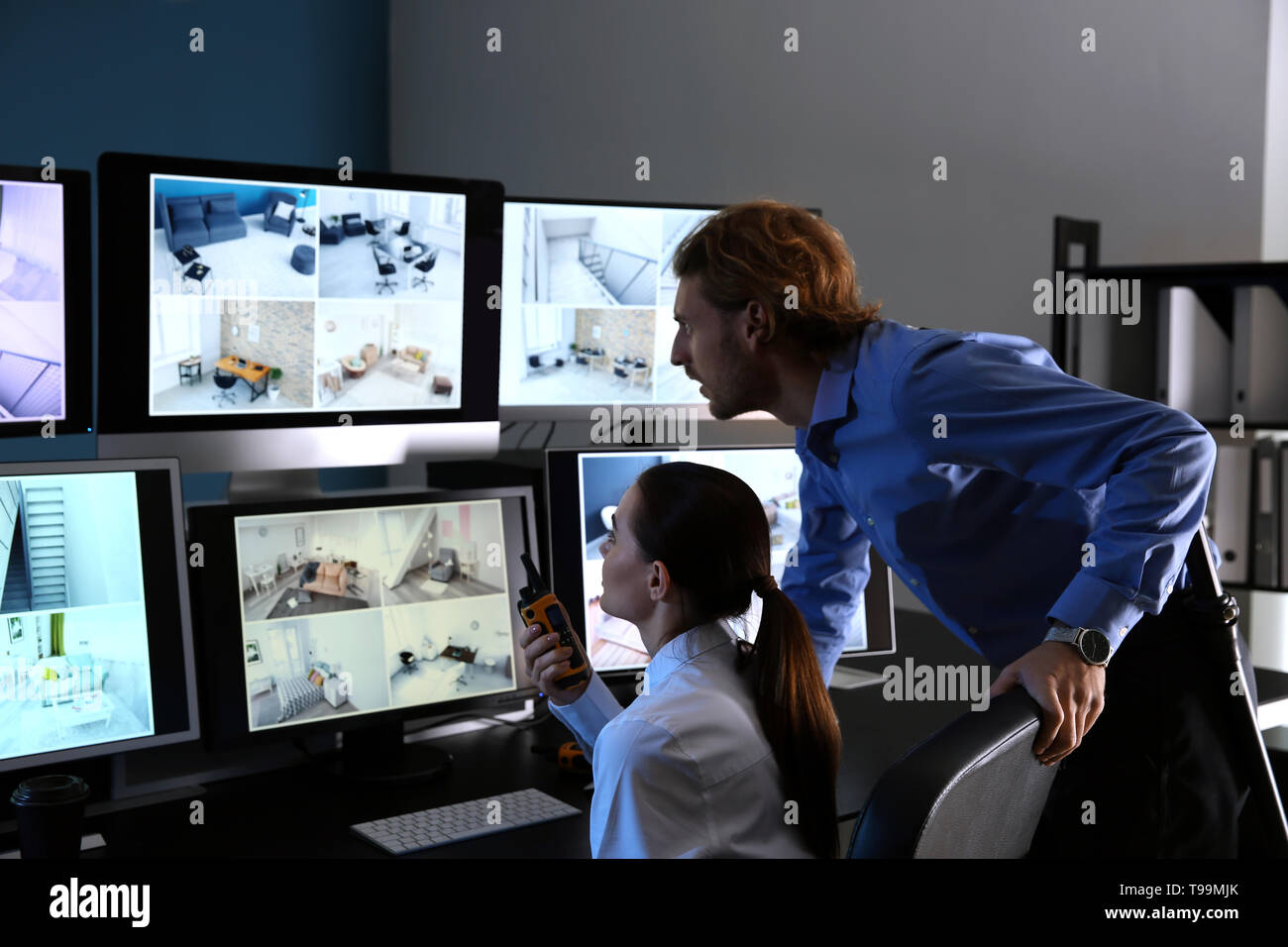 Security guards monitoring modern CCTV cameras in surveillance room ...
