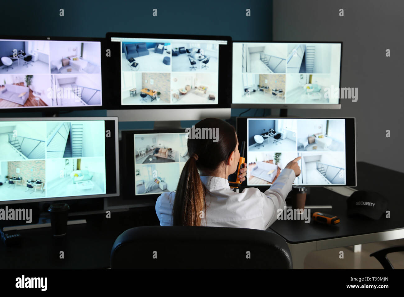 Security guard monitoring modern CCTV cameras in surveillance room ...